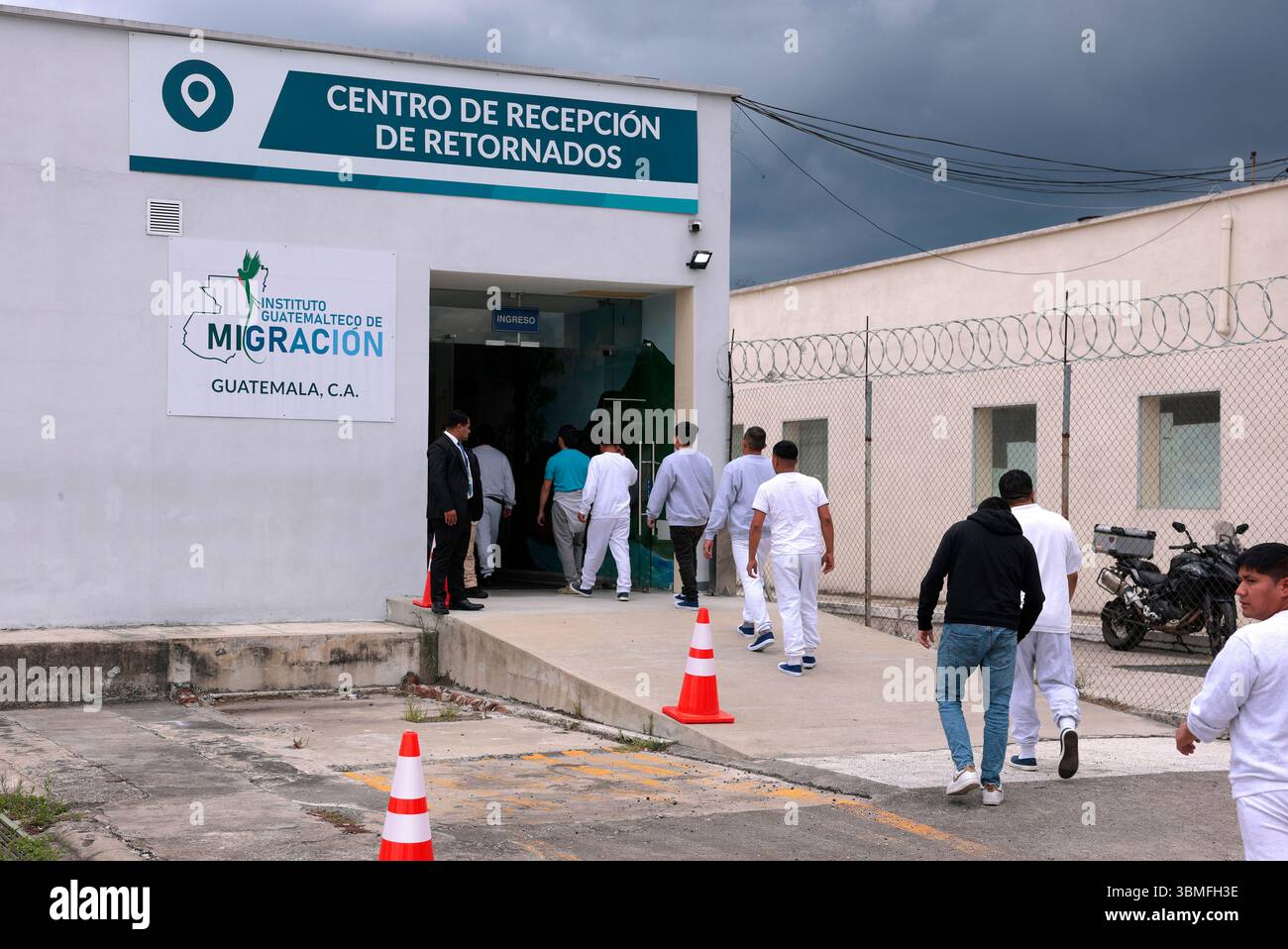 People deported from the United States walk into a processing center ...