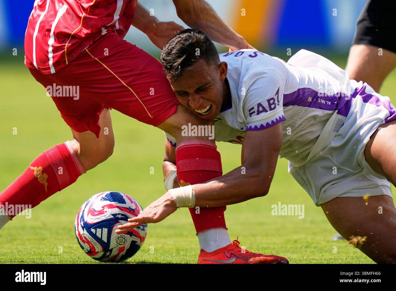 Al Ain's Soufiane Rahimi runs into Wydad AC's Oussama Zemraoui during ...