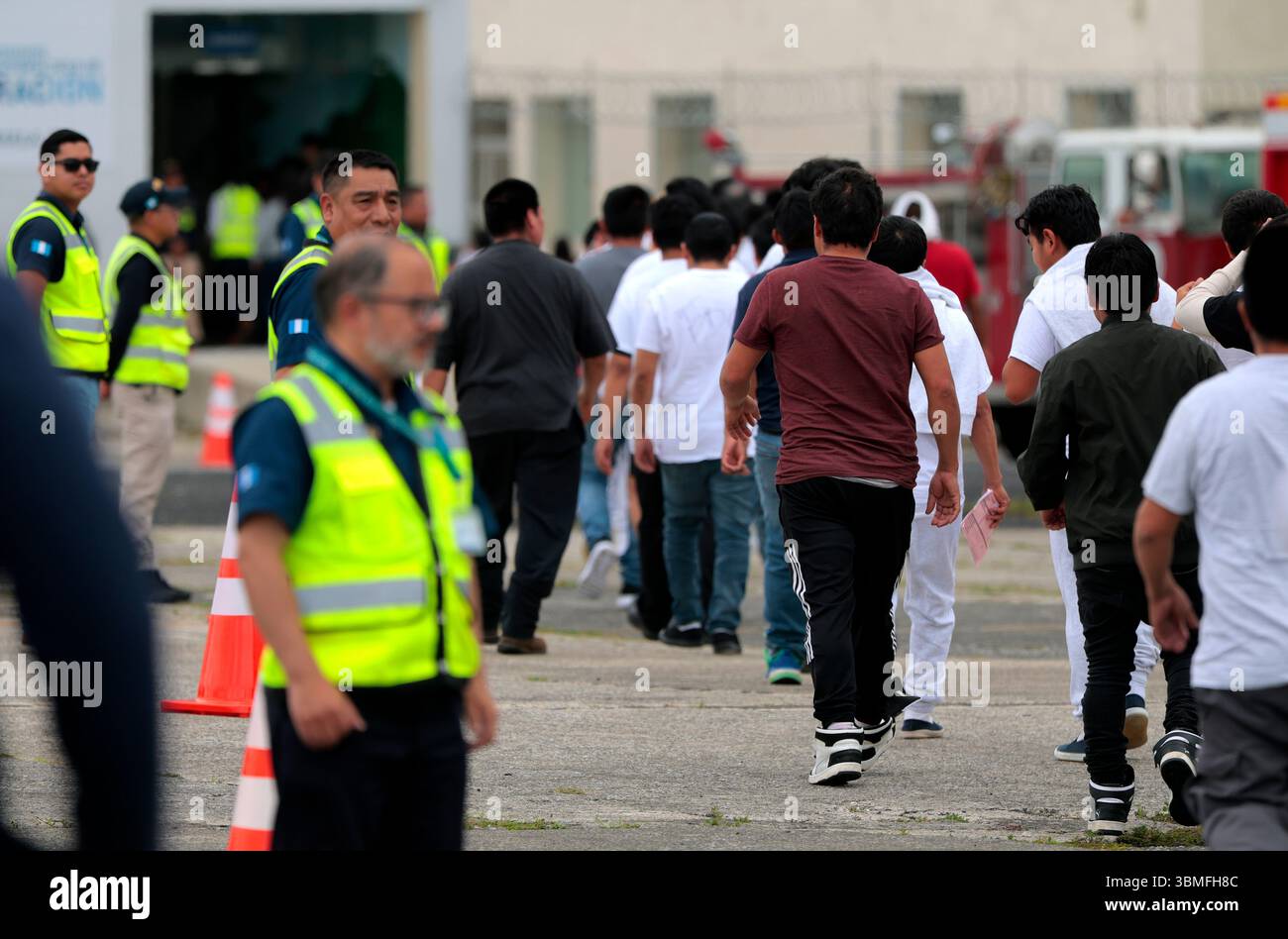 People deported from the United States walk into a processing center ...