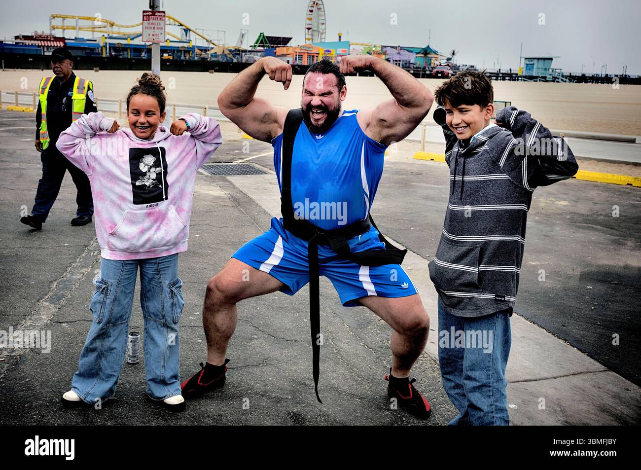 Professional strongman, Martins Licis, poses for a photo with Giovanna ...