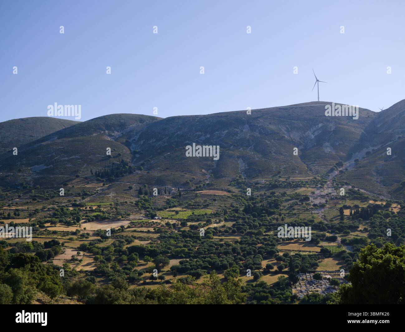 Rural valley in central Kefalonia with farmlands and a mountain range ...