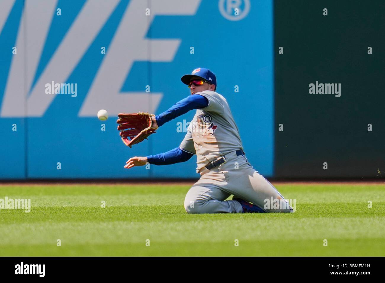 Toronto Blue Jays center fielder Myles Straw slides to catch a fly ball ...