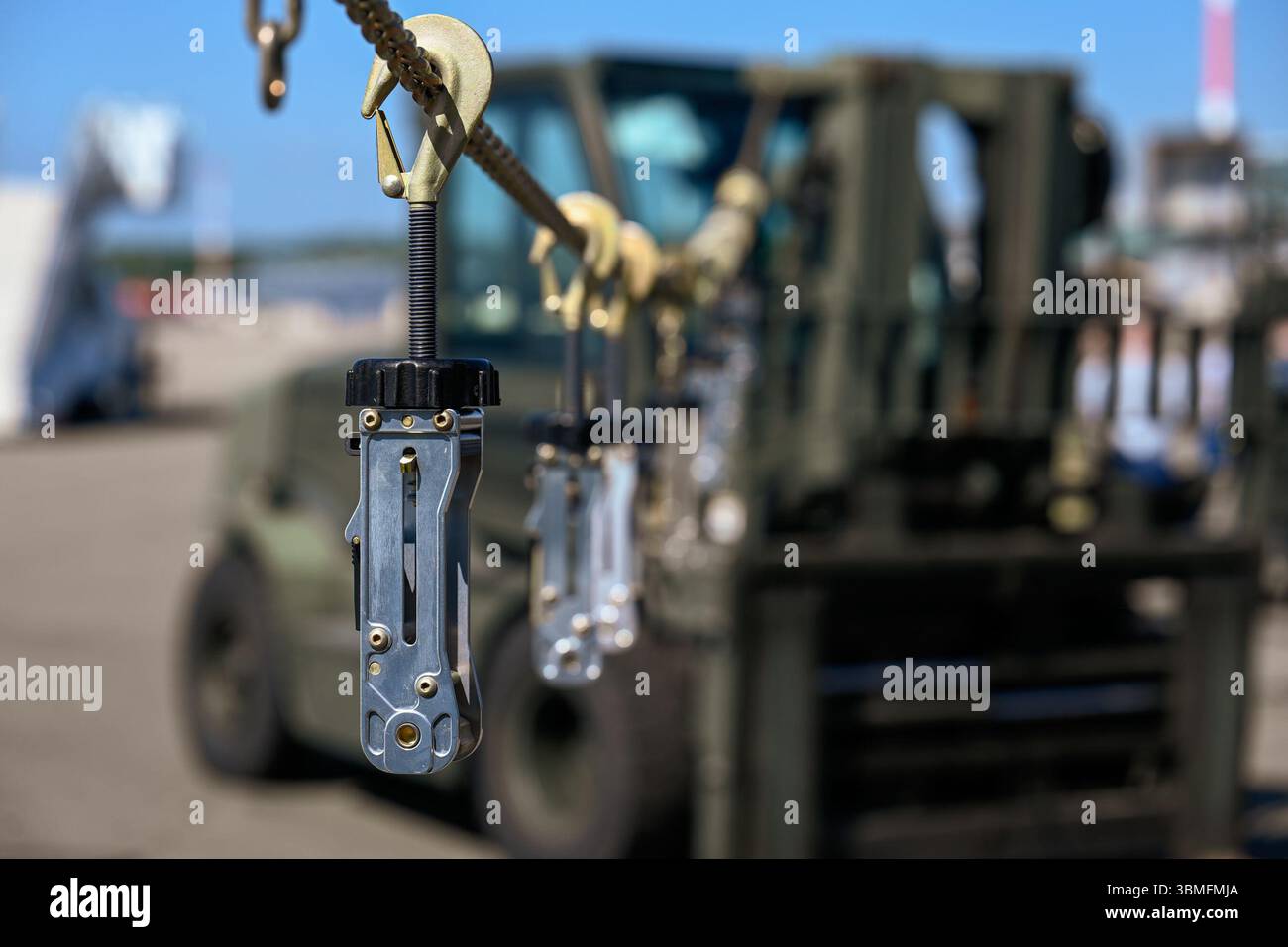 Several MB-1 devices are hung from a chain during the 721st Aerial Port ...