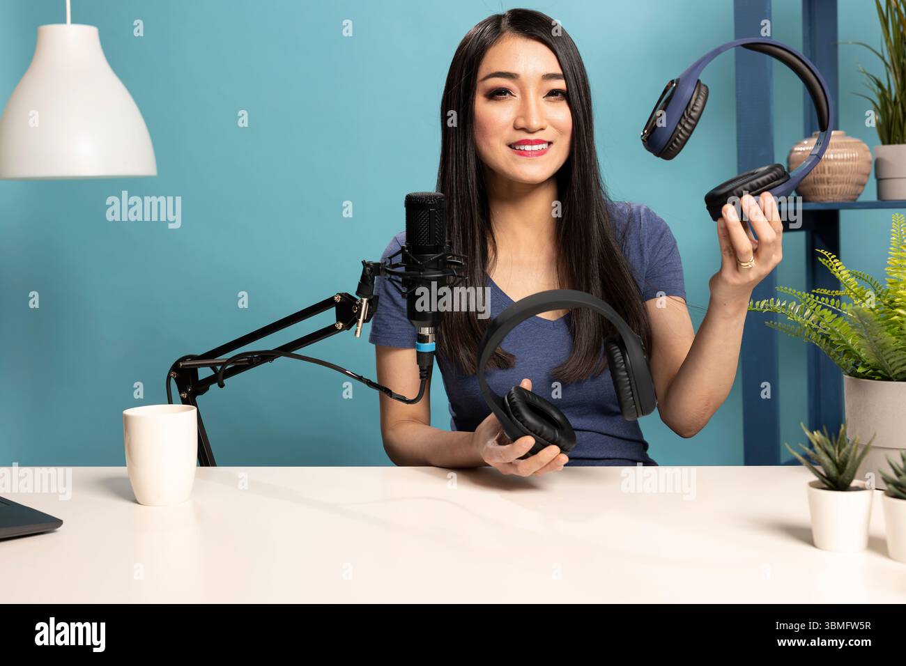 Social media influencer demonstrating and comparing two wireless ...