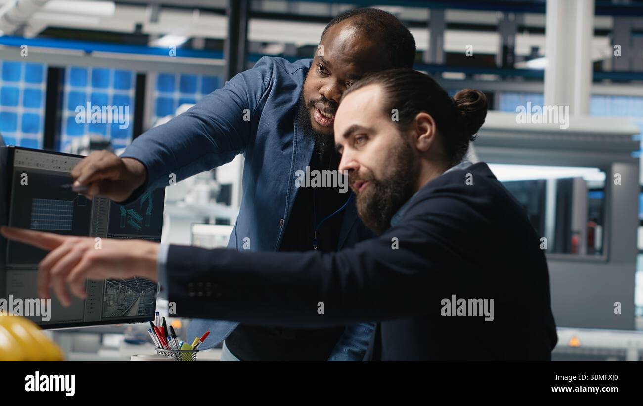 Coworkers team in the plant overseeing solar power production line ...
