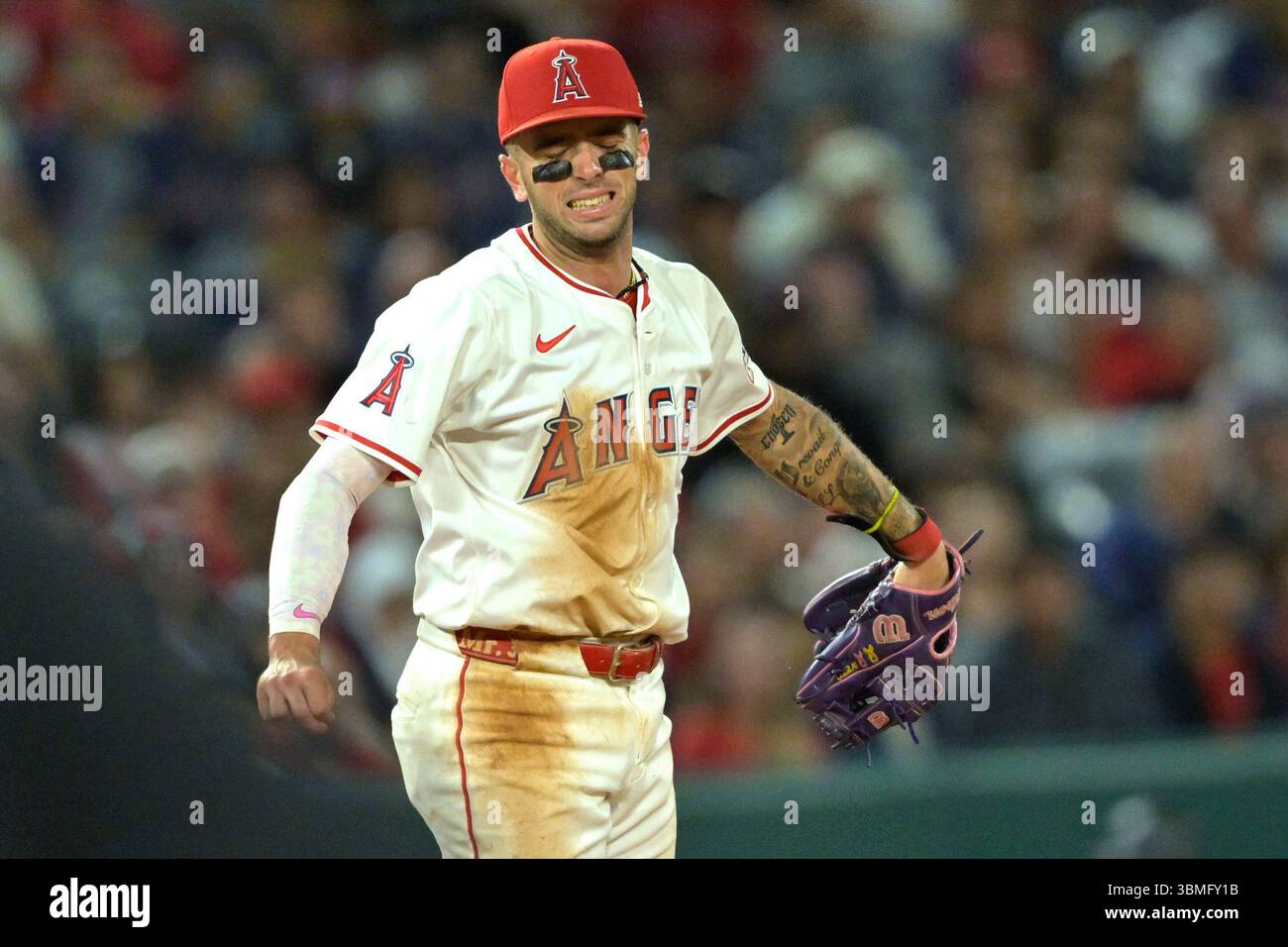 Los Angeles Angels shortstop Zach Neto grimace after making a throw to ...