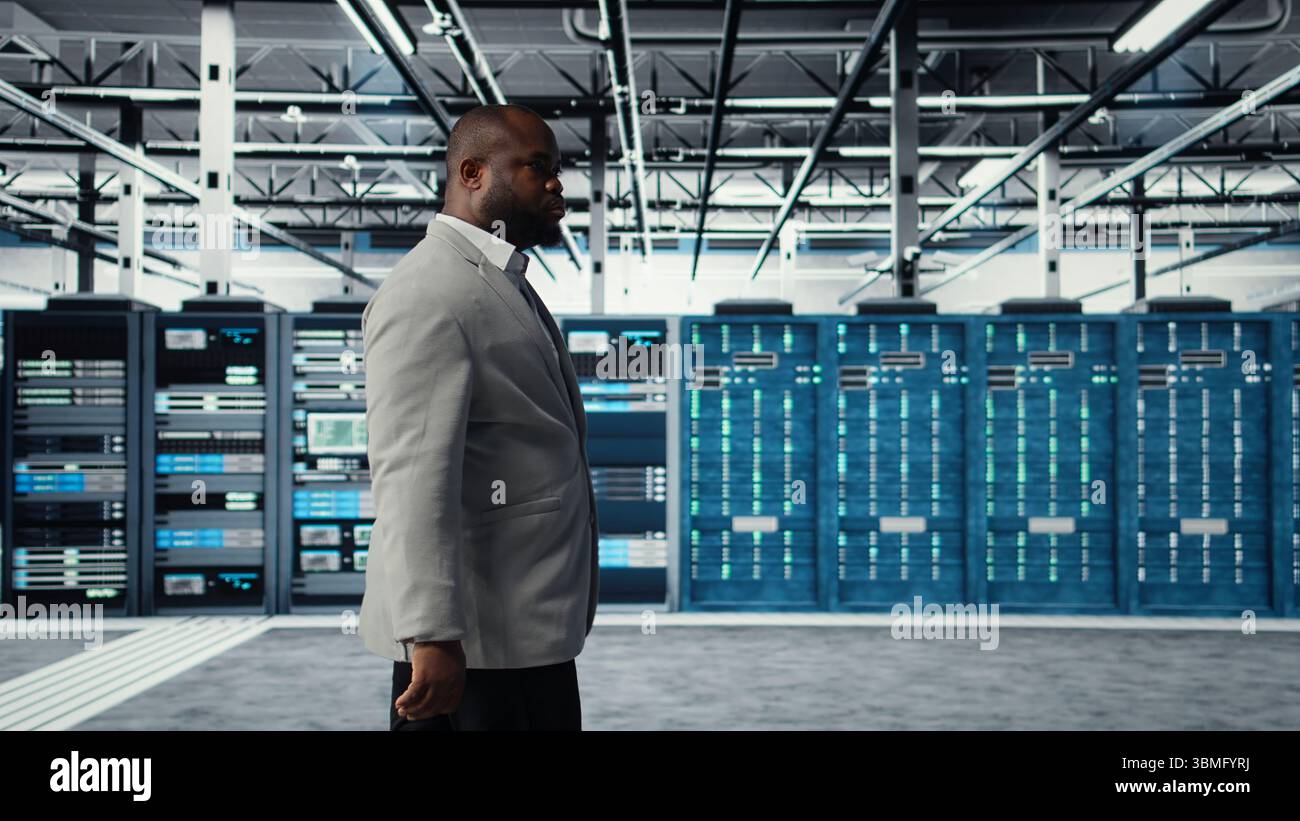 System administrator walking in data center with rigs handling queries, doing backups. Admin ...