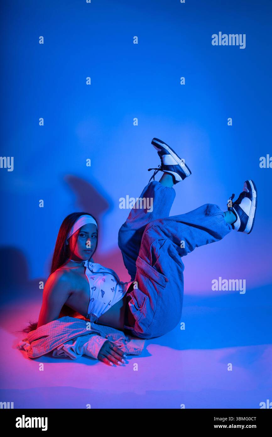 A woman is laying on her back with her legs spread apart and her arms ...