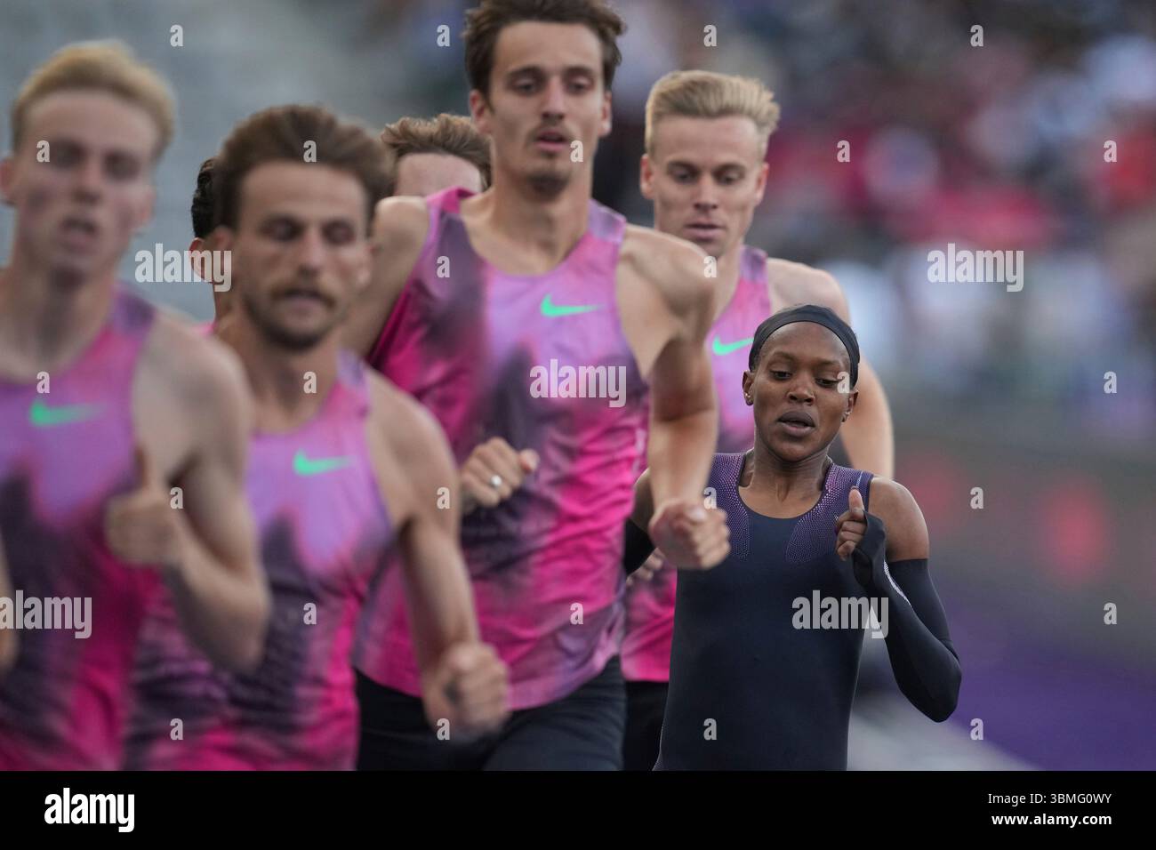 Faith Kipyegon, from Kenya, runs surrounded by her pacers in an attempt ...