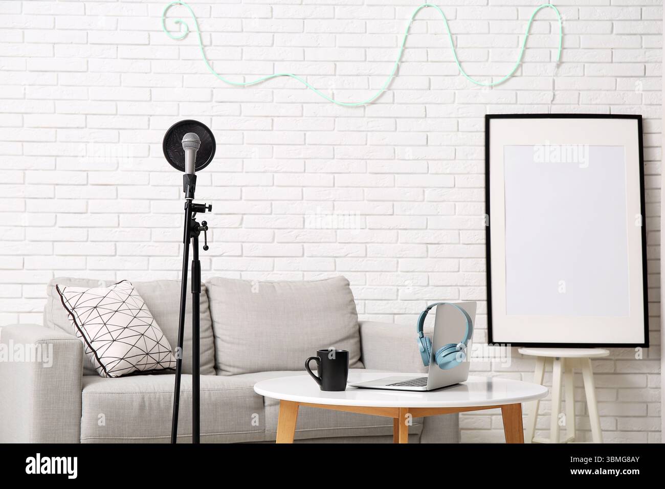 Interior of recording studio with microphone, sofa and blank frame ...