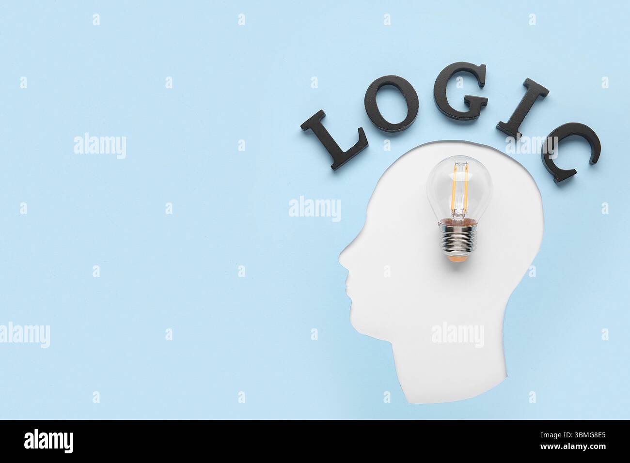 Paper human head with light bulb and word LOGIC on blue background ...