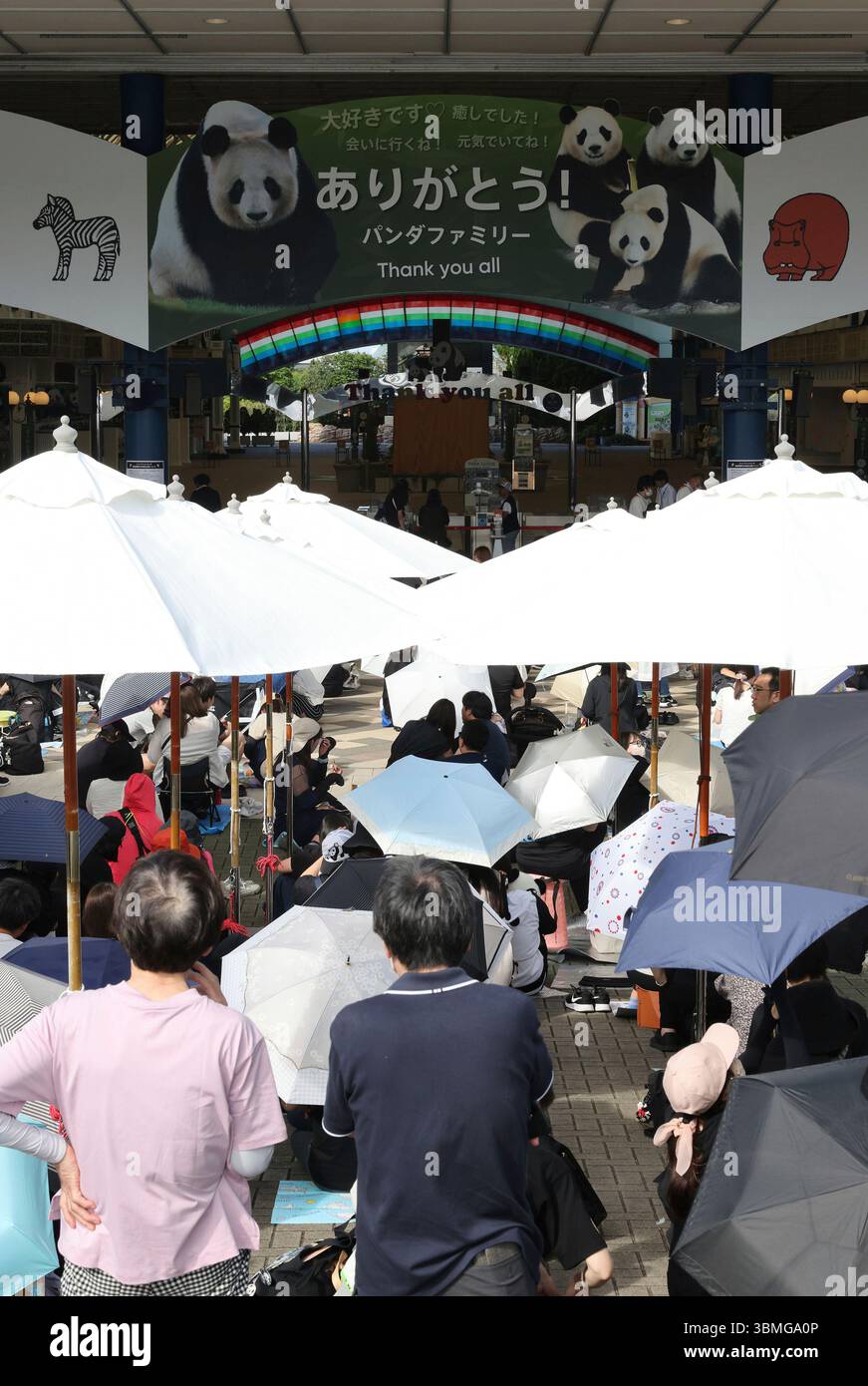 People line up before the opening of the theme park "Adventure World ...