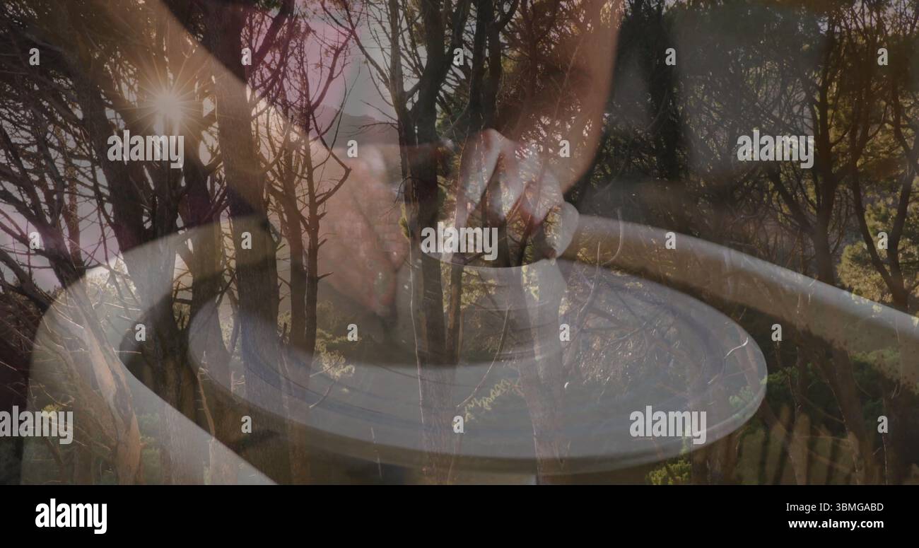 Shaping spinning clay with clay-coated hands on pottery wheel at studio ...