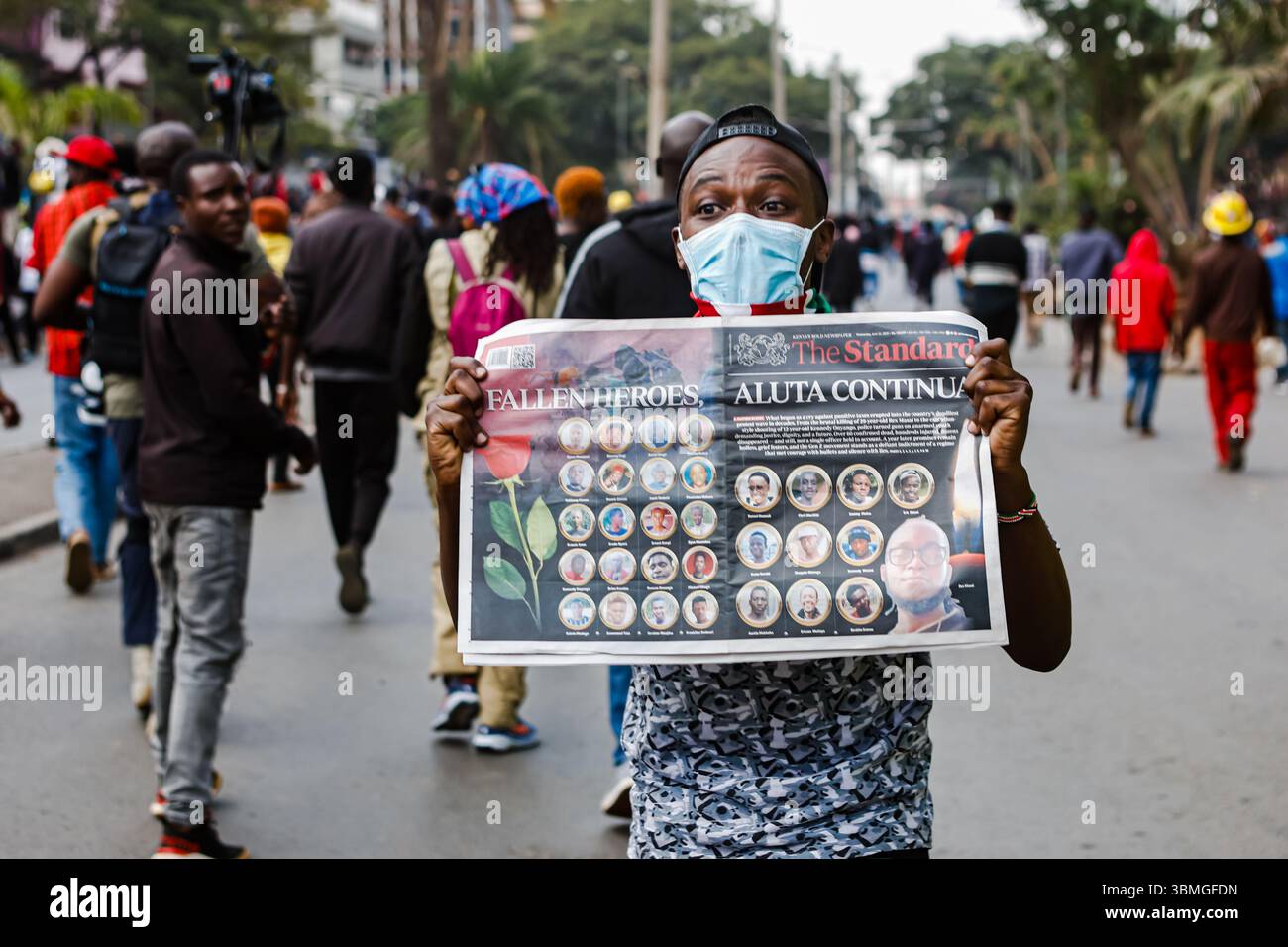 Nairobi, Kenya. 25th June, 2025. A protester holds a news paper print ...