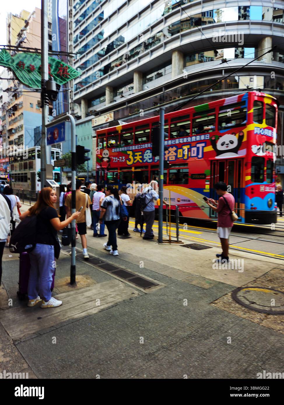 Colorful Tram and Commuters on Wan Chai Streets Stock Photo - Alamy