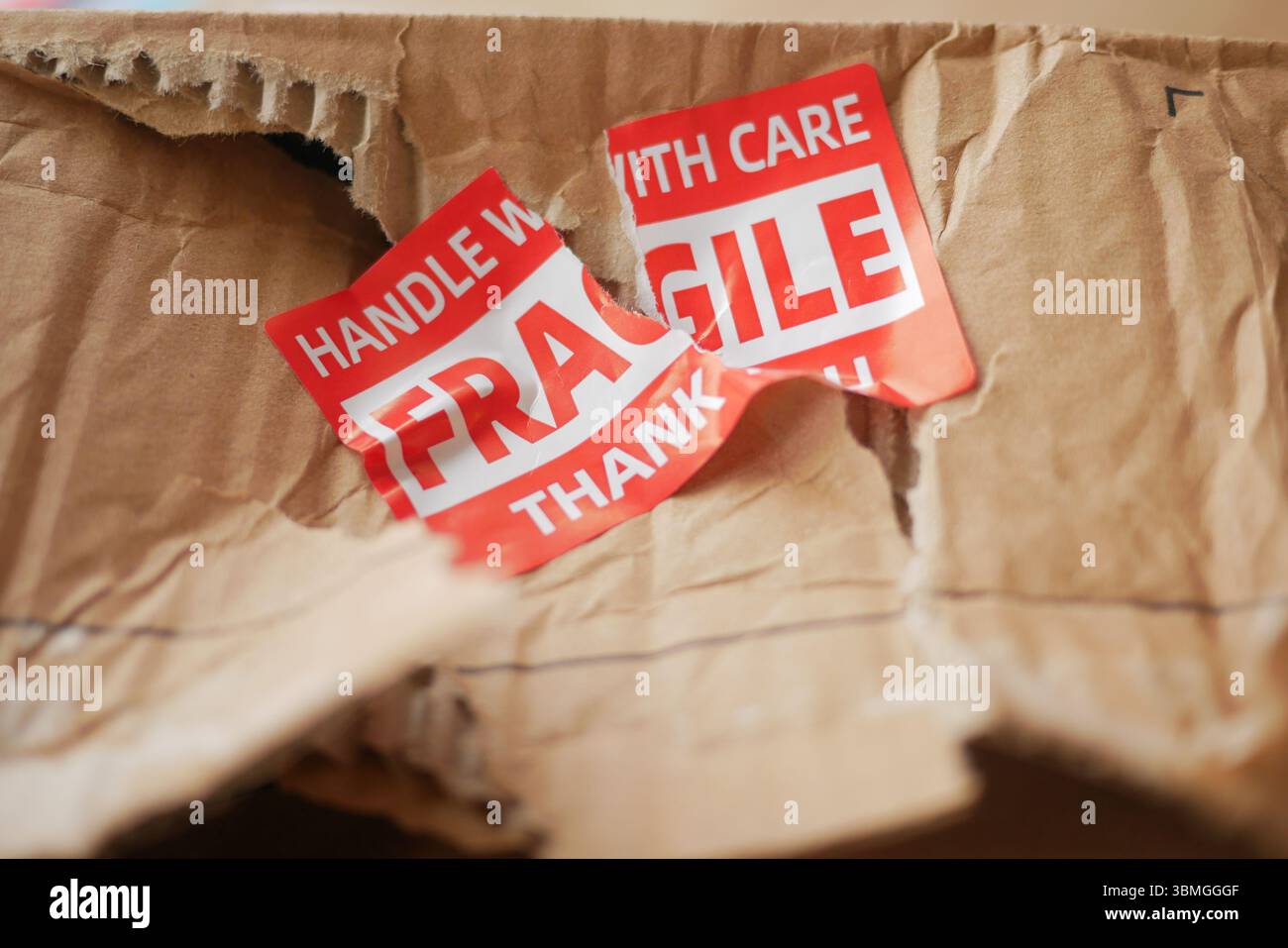 Delivery box damaged with fragile stickers at home Stock Photo - Alamy