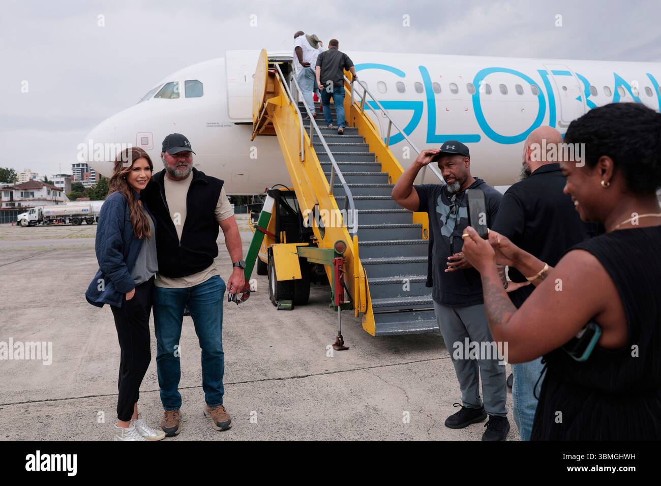 U.S. Homeland Security Secretary Kristi Noem poses for photos with air ...