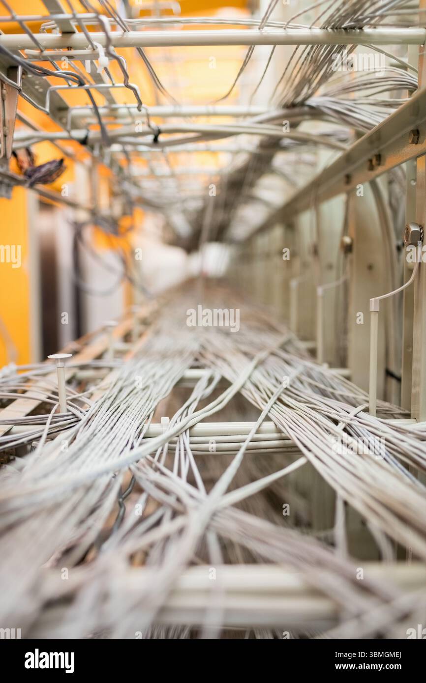 White and gray network cables are stretching along metal trays in 3D ...