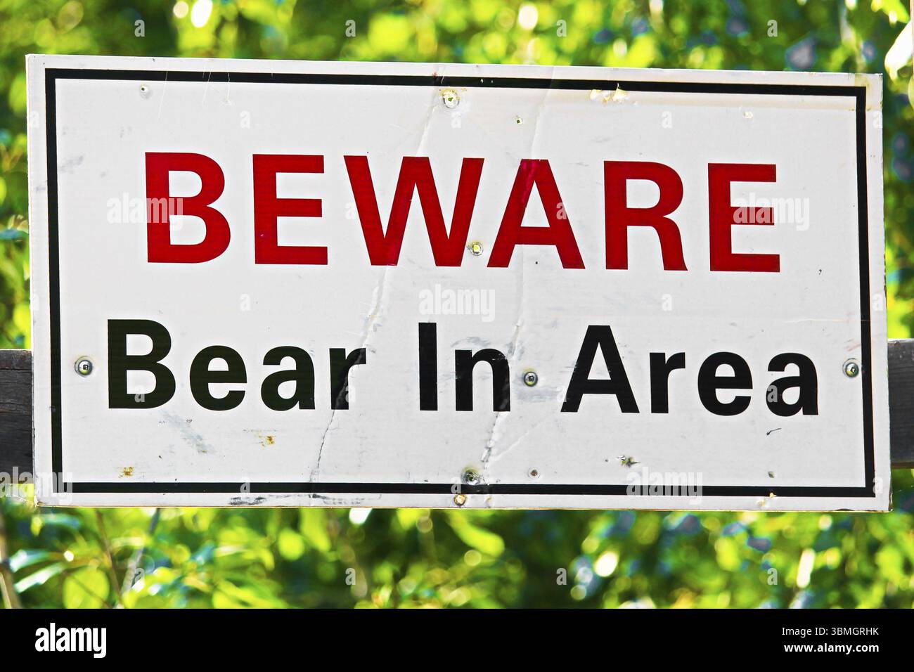 A white beware bear in area sign Stock Photo - Alamy
