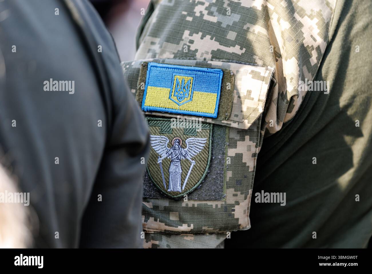 16 June 2025, Ukraine, Butscha: The Ukrainian flag with the trident ...