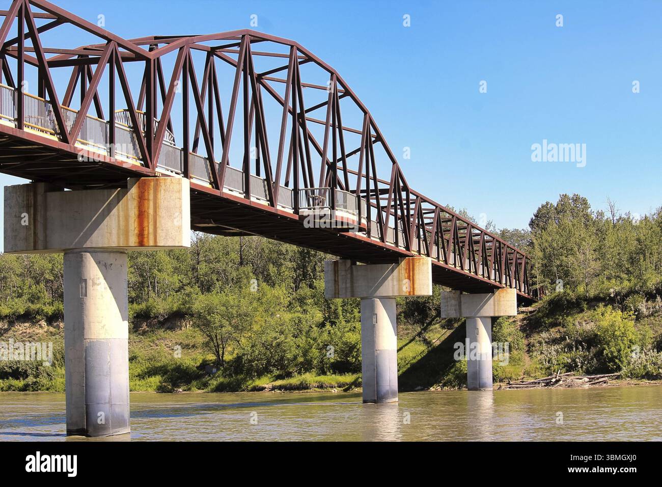 A foot bridge over a river in summer Stock Photo - Alamy