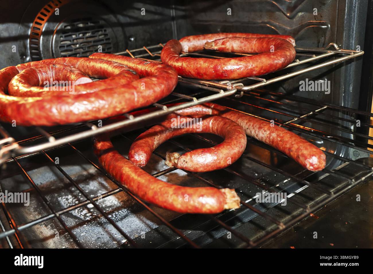 Racks of ham sausages drying in an oven after being boiled Stock Photo ...
