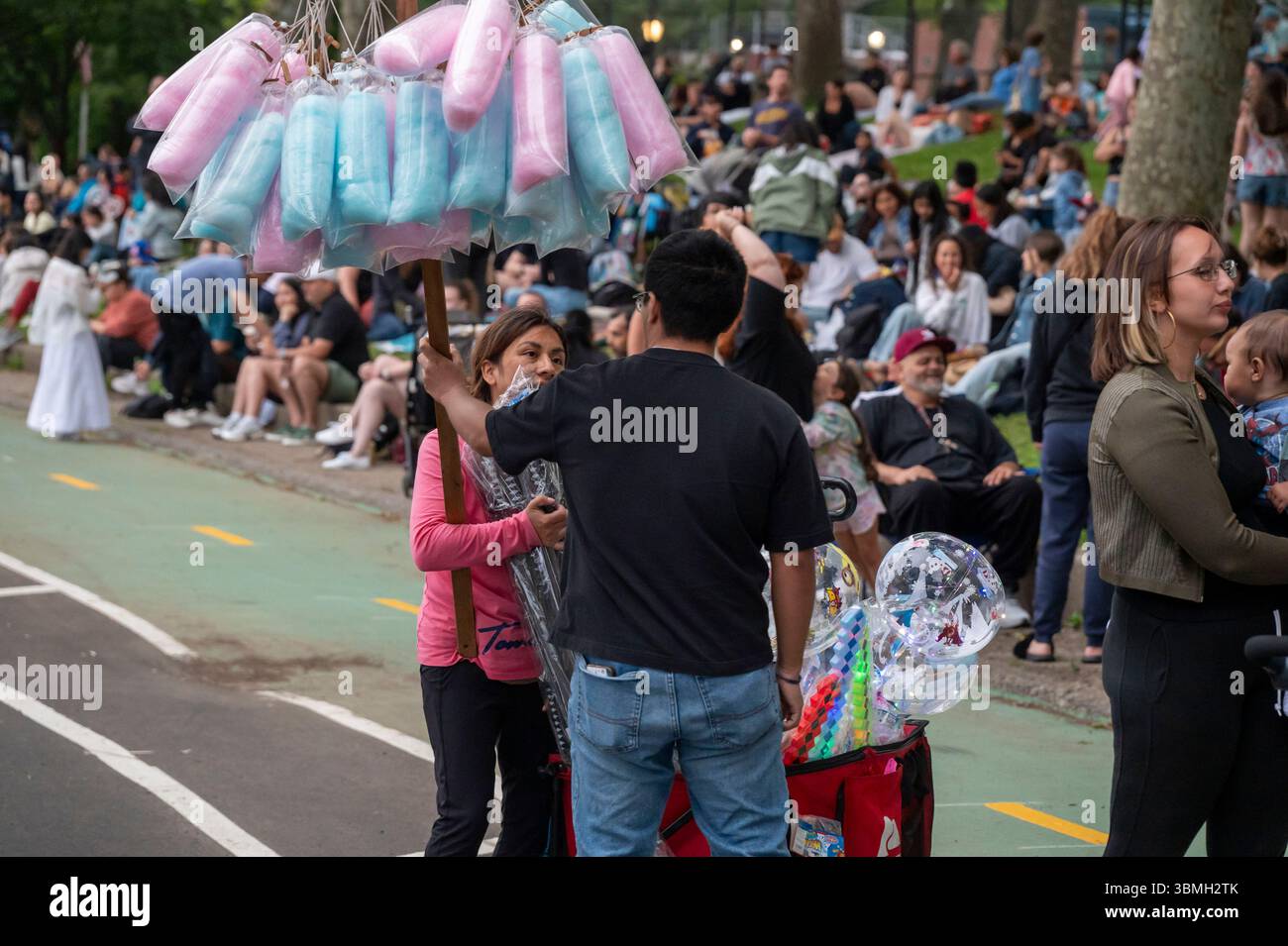 Vendors sales cotton candy and lanterns as spectators gather for the ...