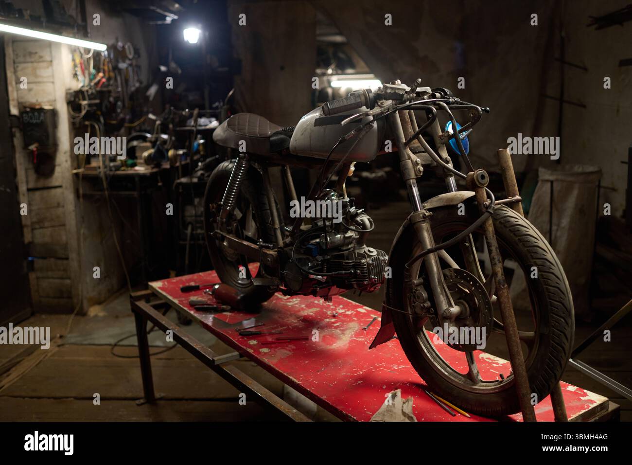 Custom Motorcycle in Workshop Setting Stock Photo - Alamy