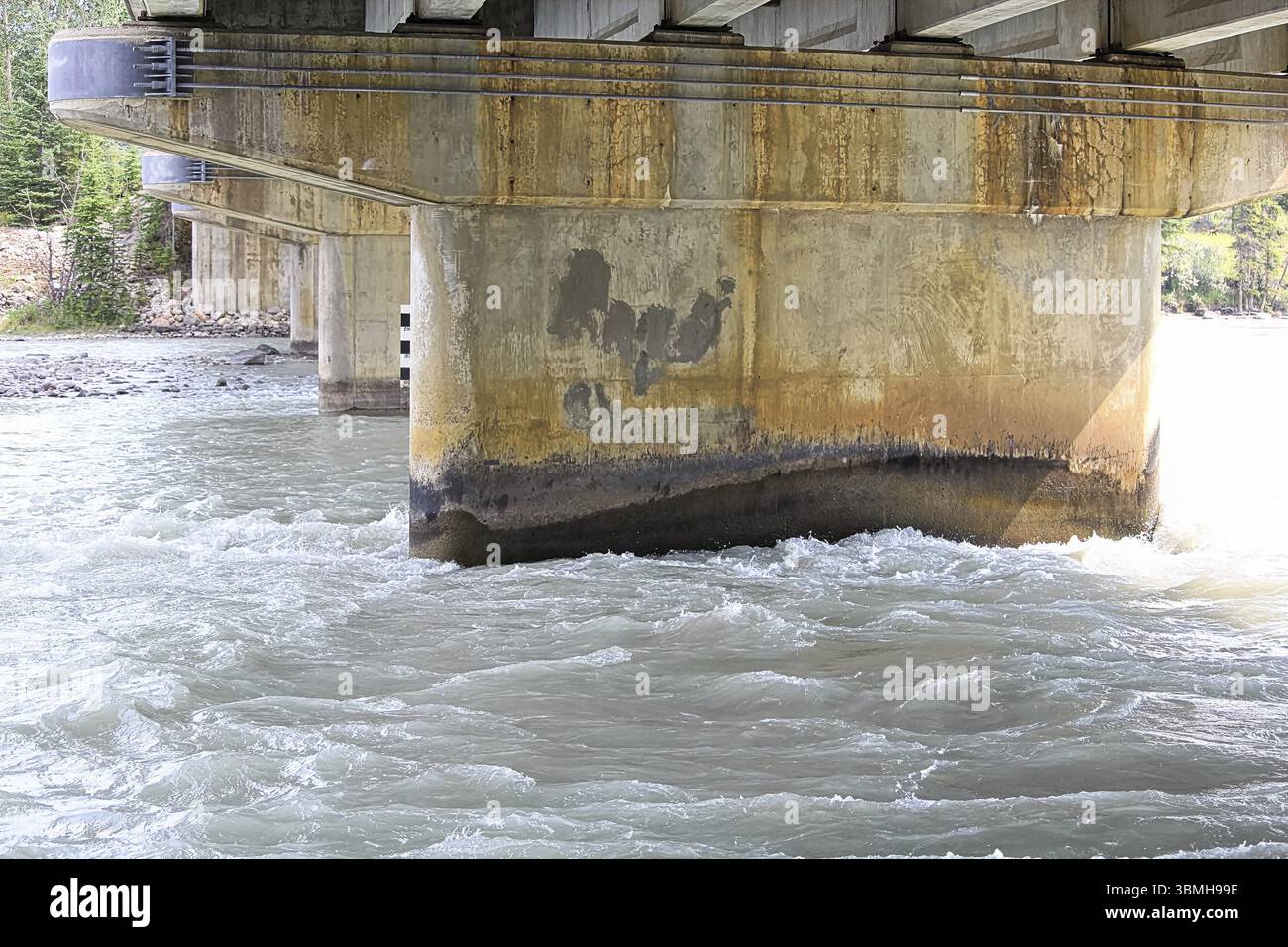 Water flowing fast under a concrete bridge Stock Photo - Alamy