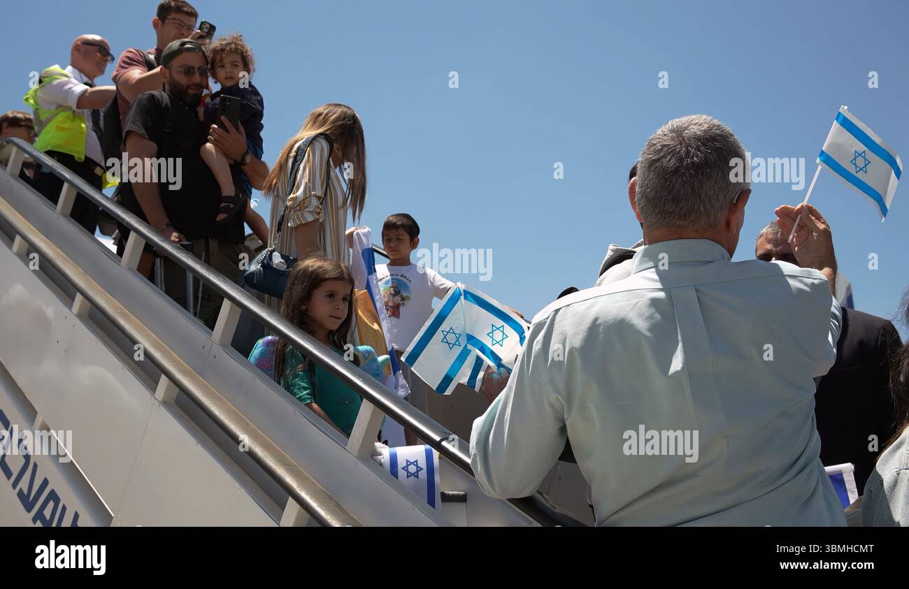 LOD, ISRAEL - JUNE 25: Jewish immigrants from Europe are handed Israeli ...