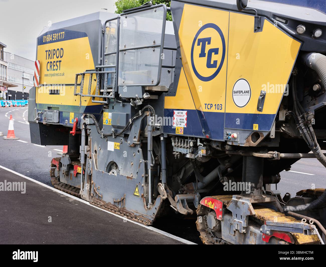 Tarmac breaking machine for road repairs in Corby town centre, England ...