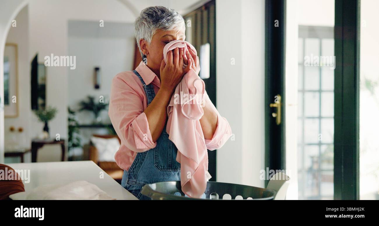 Sniffing, cloth and woman with laundry, home and smell of clean washing ...