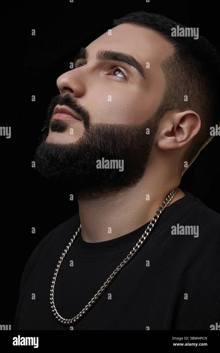 A dramatic portrait of a young serious guy, musician, singer, rapper ...