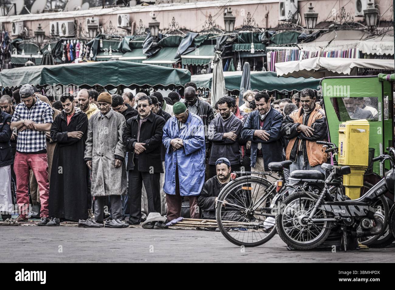 Muslims praying in front of a mosque, Jamaa el Fna Square, Marrakech ...