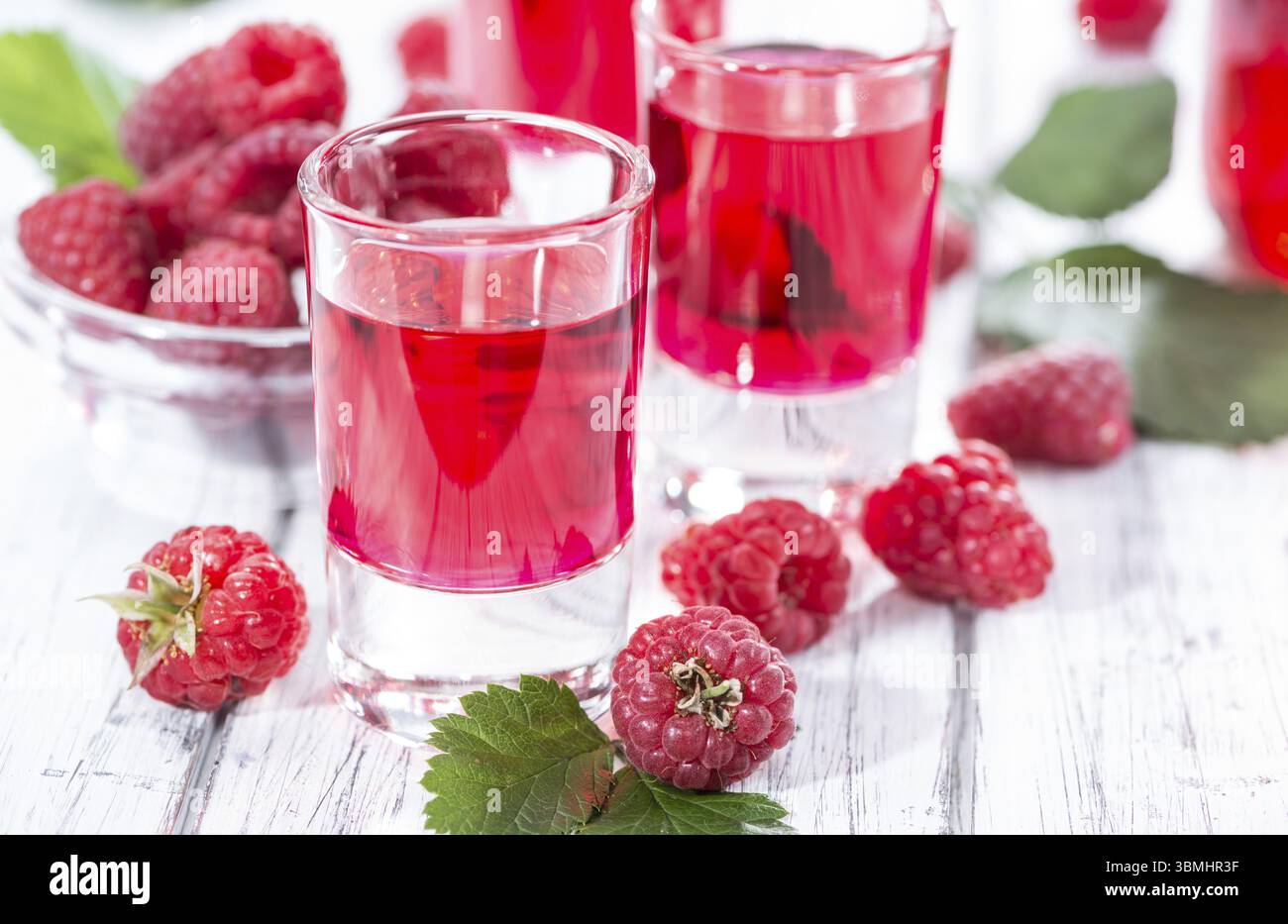 Homemade Raspberry Liqueur in a glass with some fresh fruits Stock ...