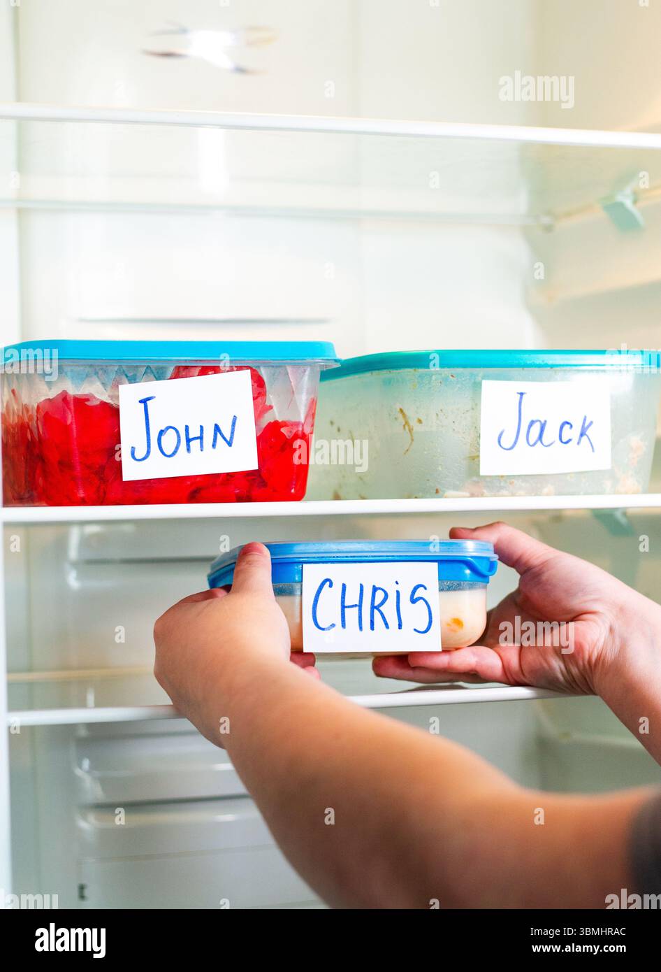 Meal containers labeled with employee names in clean office ...