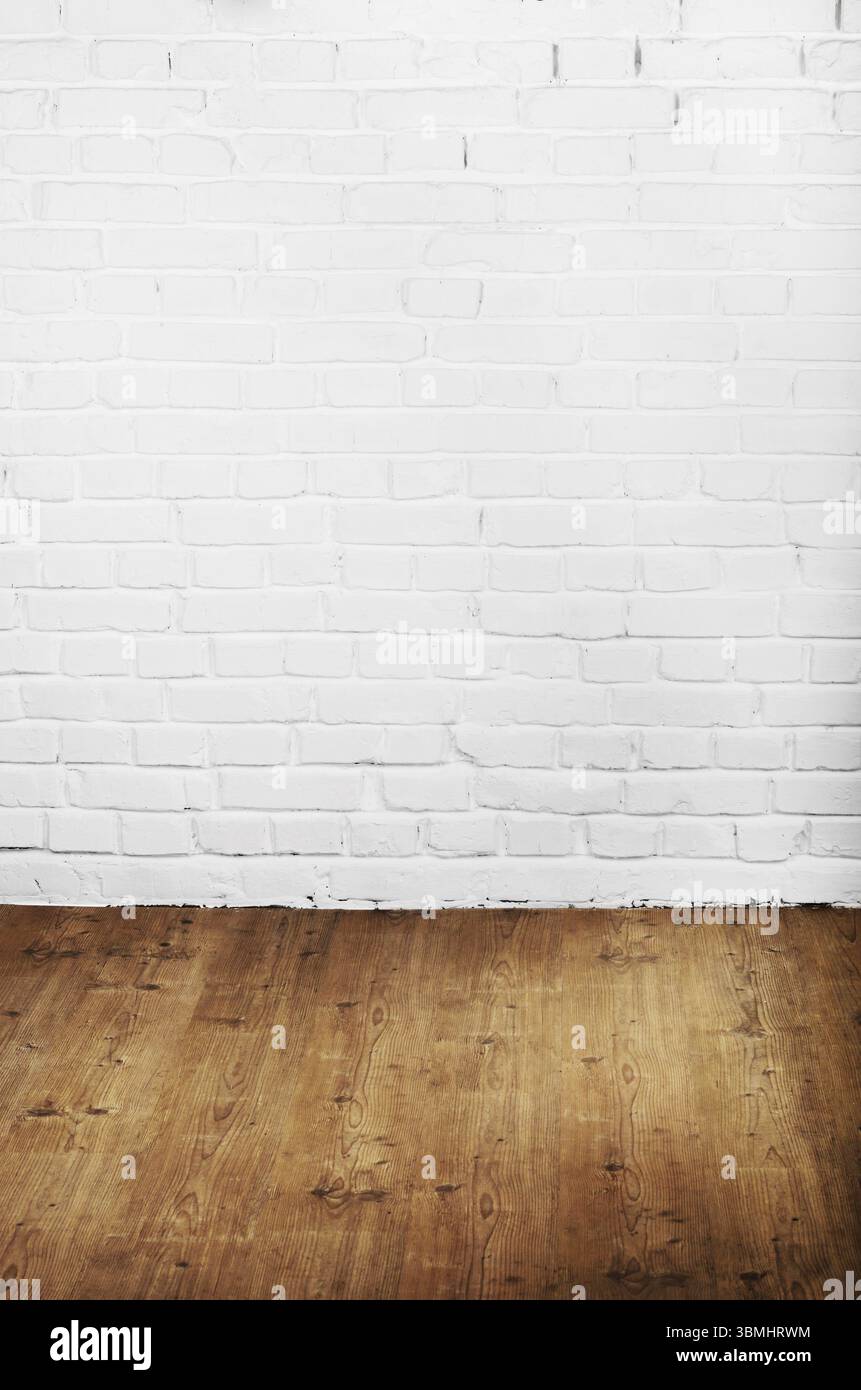 White brick wall of painted genuine clay blocks and wooden floor ...