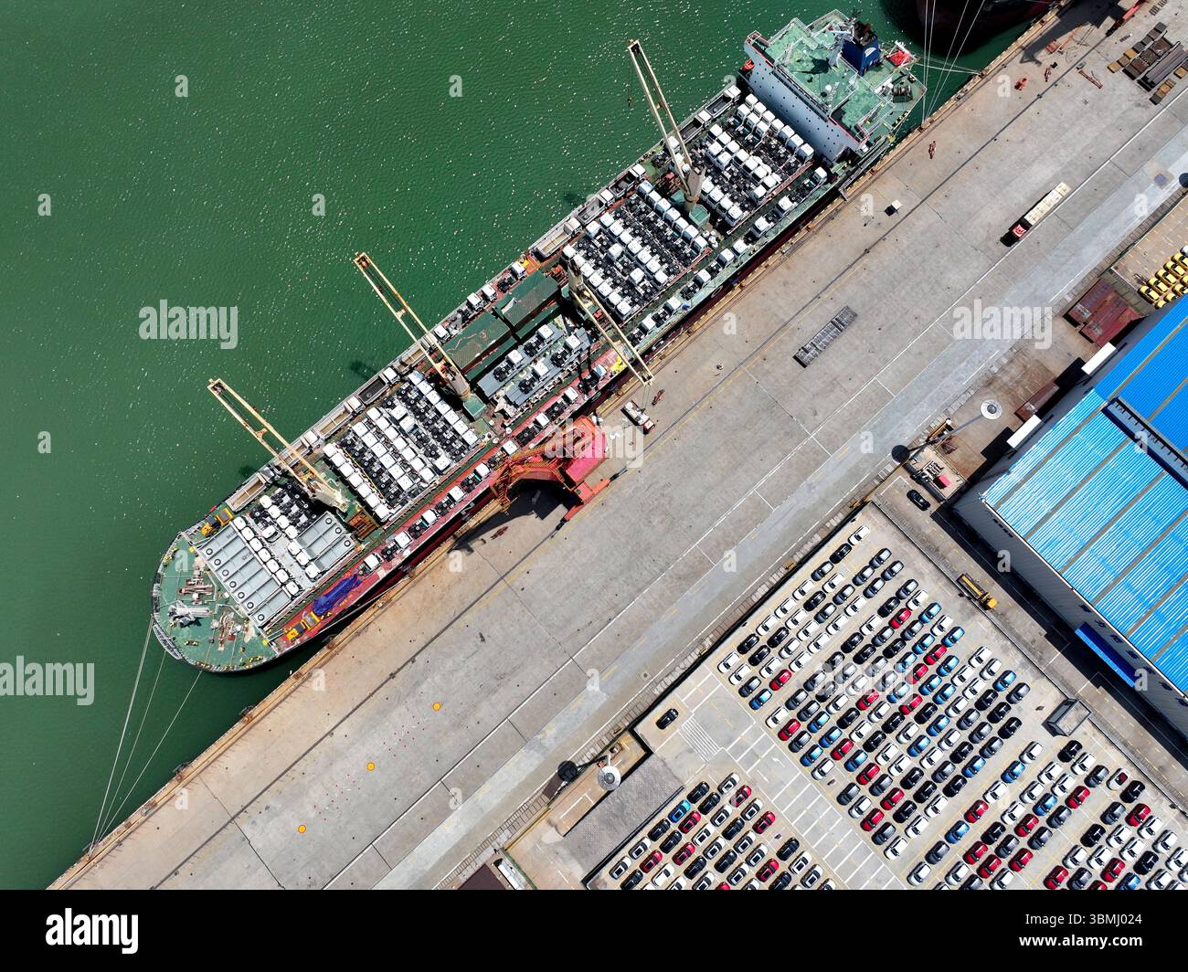 Aerial photo shows export-bound machineries and vehicles await loading ...