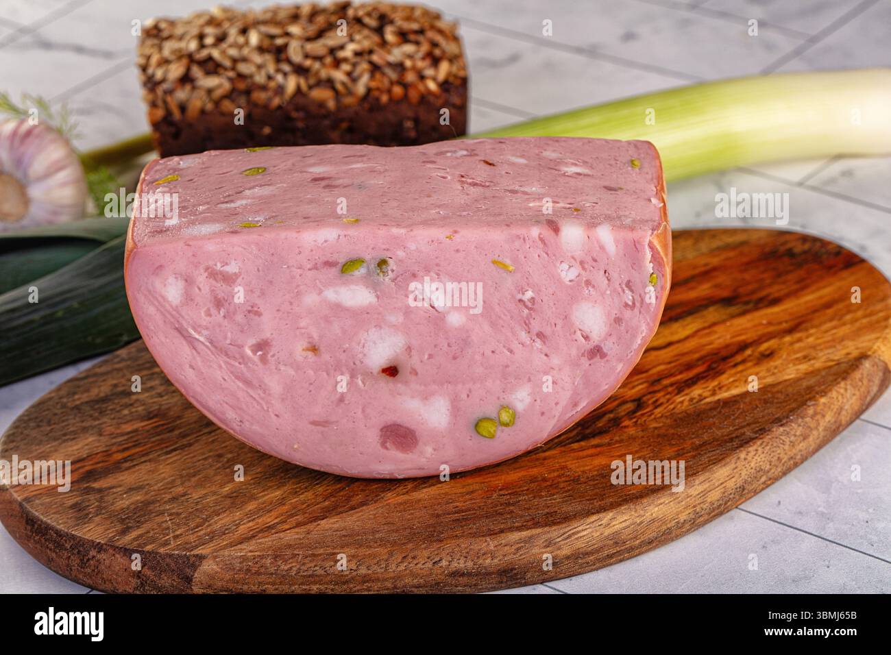 Italian Mortadella pork sausage piece with pistachios Stock Photo - Alamy
