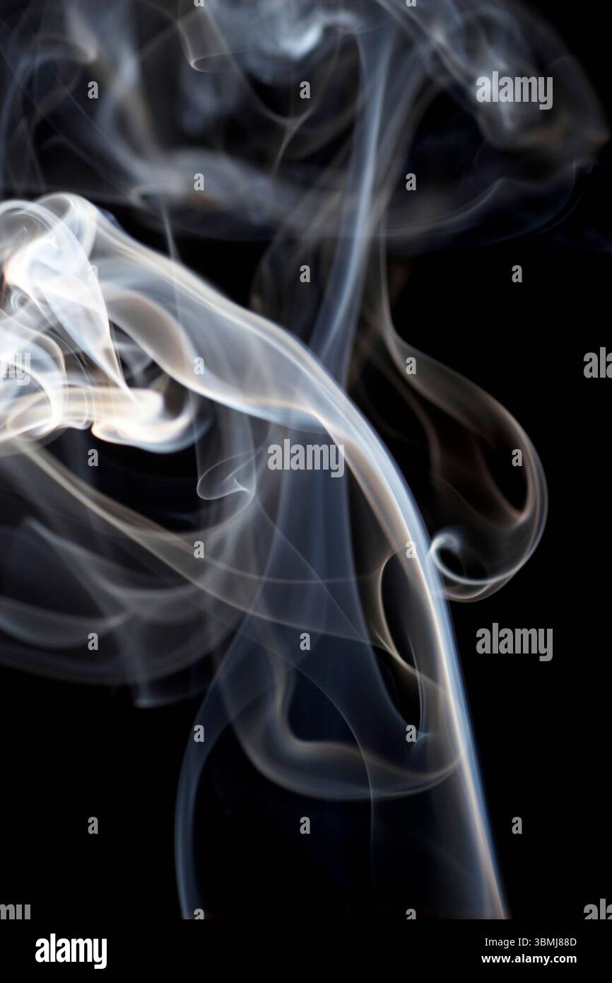 Smoke trails from a burning cigarette Stock Photo - Alamy