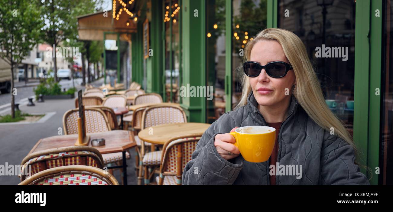 Tourist enjoying a coffee at a parisian outdoor cafe Stock Photo - Alamy