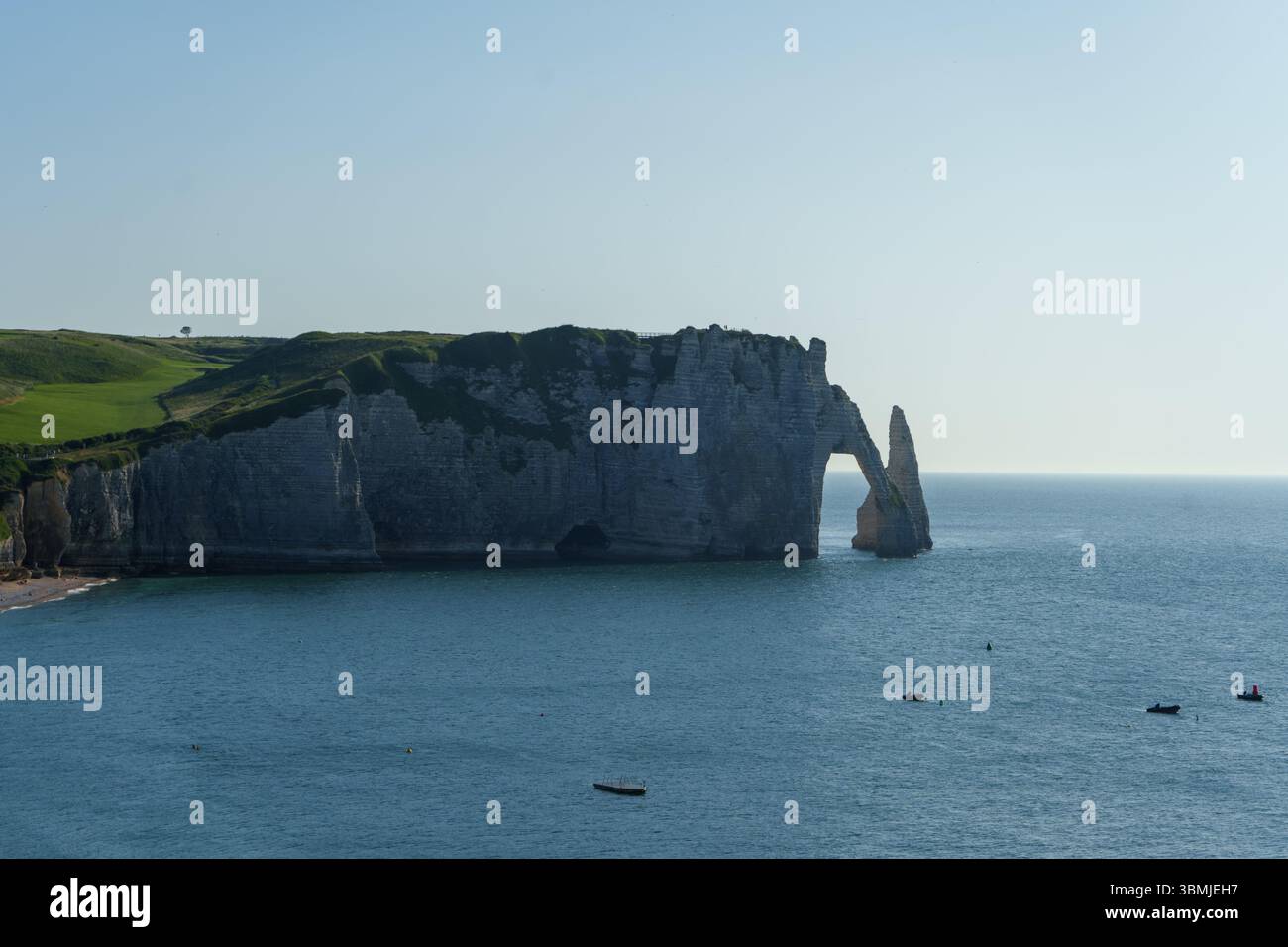 The dramatic white chalk cliffs and natural arches of Étretat on the ...