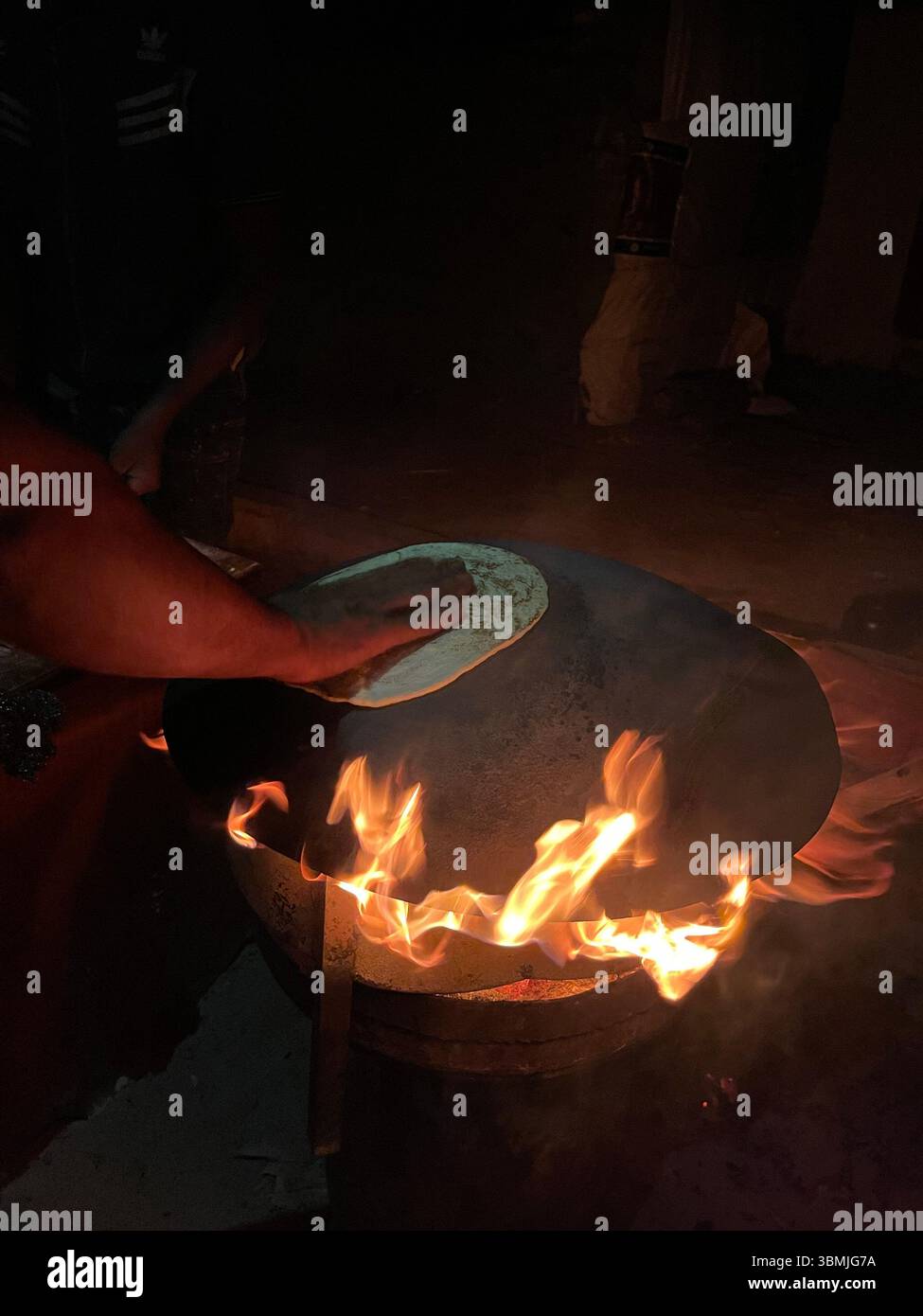 Baking Saj bread with firewood, traditional Arabic countryside bread ...
