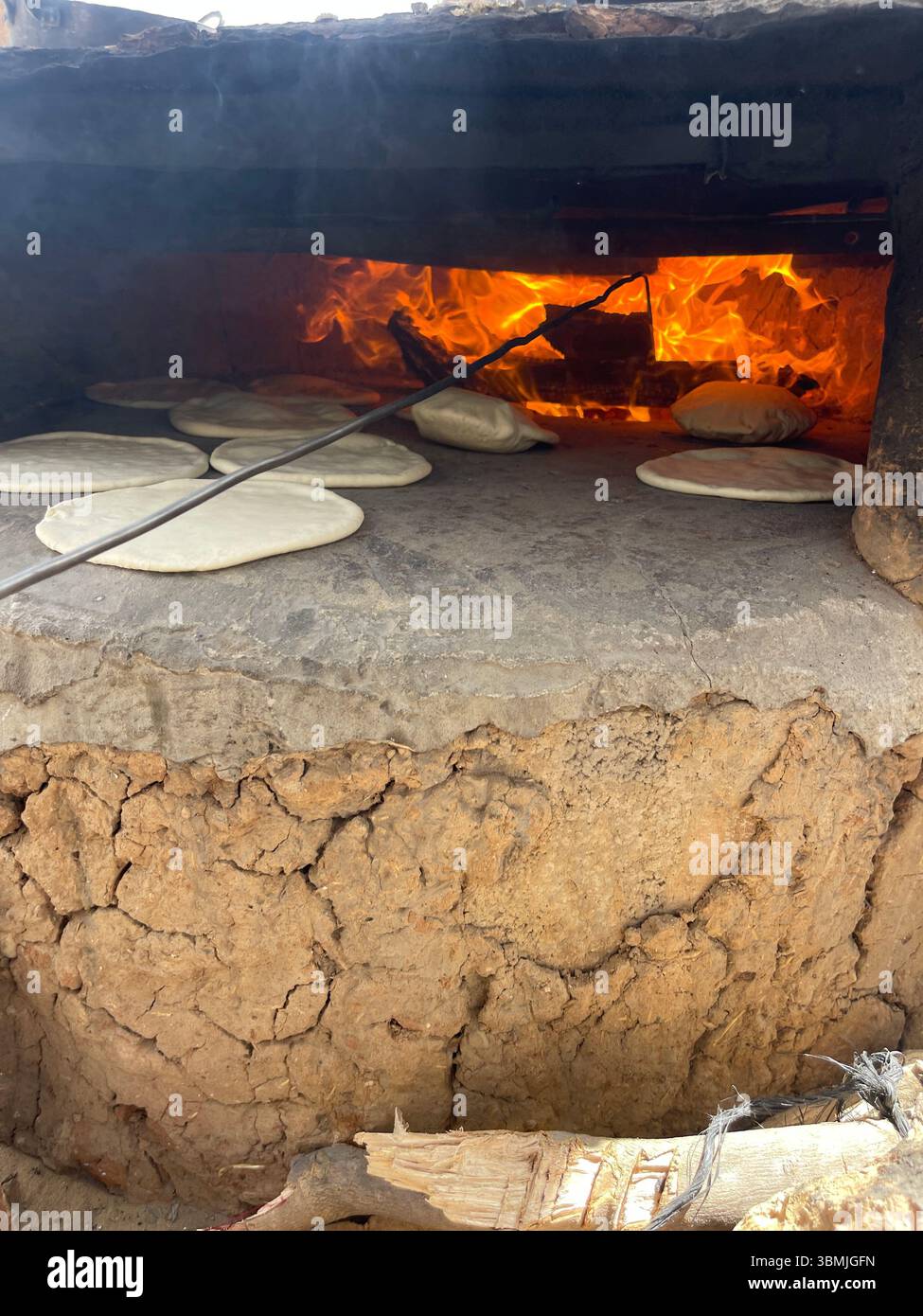 Baking bread in a clay oven, traditional baking method Stock Photo - Alamy