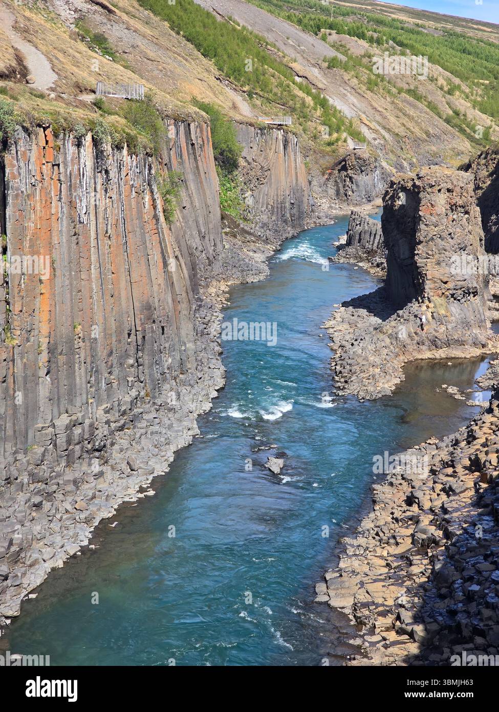 Marvel at Studlagil Canyon in Iceland, where tall basalt cliffs rise ...