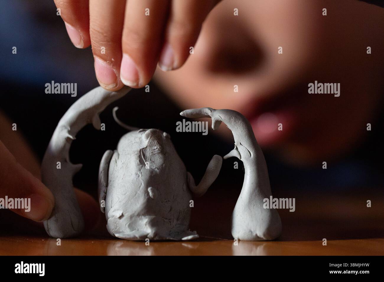 Kid molding grey modelling clay, developing imagination and fine motor ...