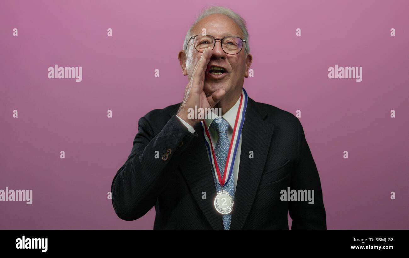 Senior man in business suit with medal over isolated pink wall ...