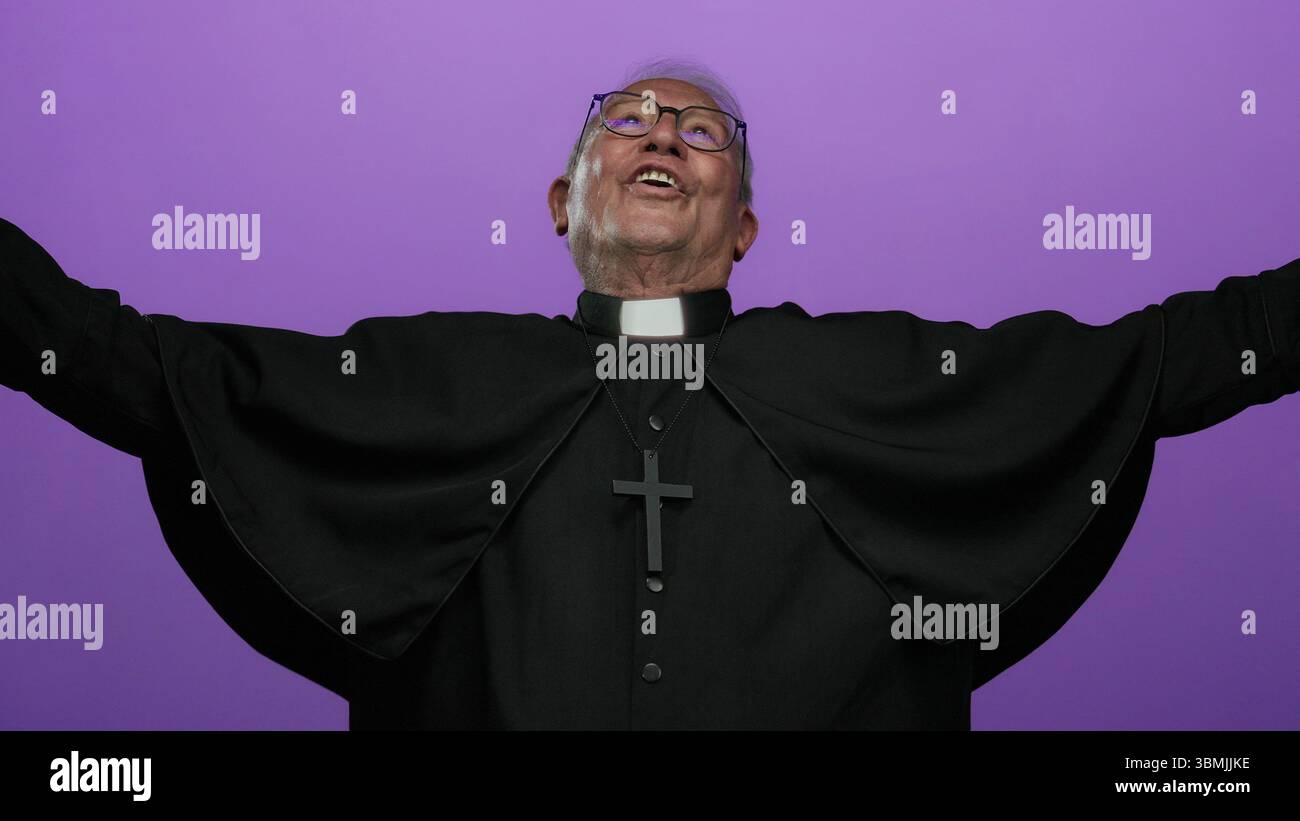 Senior priest joyfully raising arms hi-res stock photography and images ...