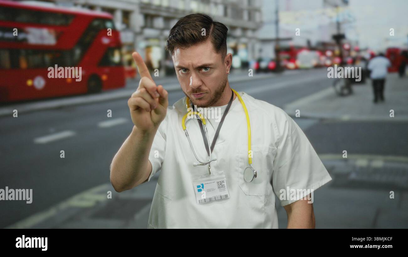 Young doctor with beard pointing finger on busy city street background ...
