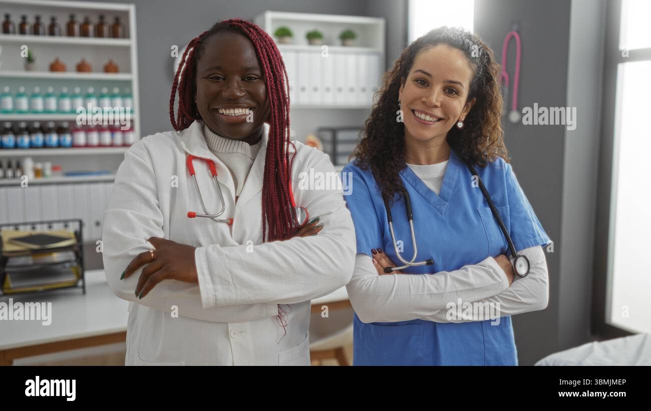 Two smiling doctors stand confidently in a hospital room, showcasing ...